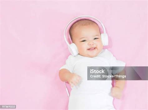 아시아 아기 소녀 착용 흰색 헤드폰 과 흰색 셔츠 에 핑크 배경 6 11 개월에 대한 스톡 사진 및 기타 이미지 6 11