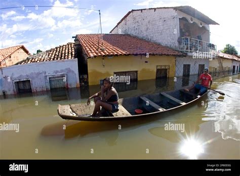 In This May 9 2009 Photo A Man Rows A Boat Through A Flooded Street
