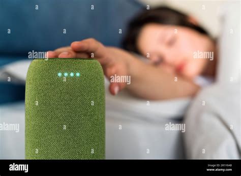 A Sleeping Woman Turning Off Alarm Clock On A Portable Wireless Speaker With 4 Luminous Diodes