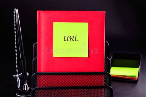 Brightly Colored Notebook With Sticky Note Labeled Url On Black Desk Organizer In Modern