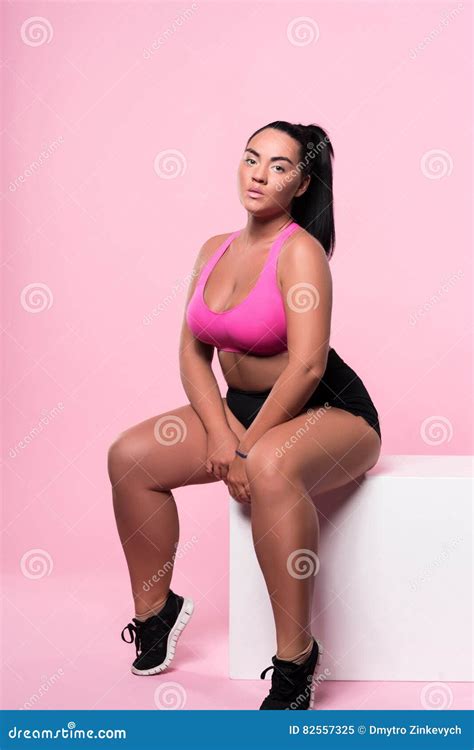 Plump Mulatto Woman Sitting On Pink Background Stock Image Image Of