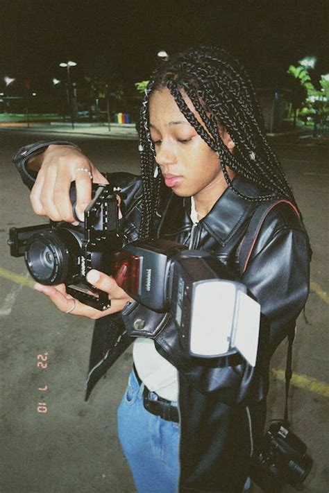 Close Up Shot Of A Woman In Black Leather Jacket Holding A Camera