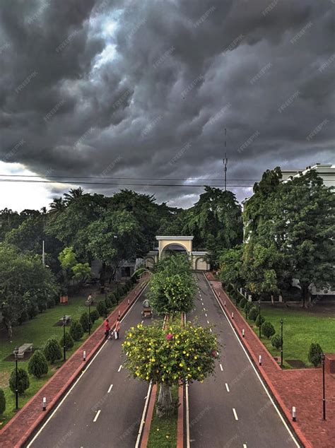 Premium Photo Roads And Cloudy Weather A Road With Trees And Cloudy Weather In The Background