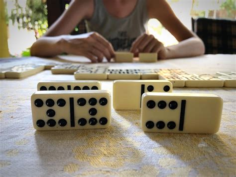 Premium Photo Midsection Of Woman Playing Domino On Table
