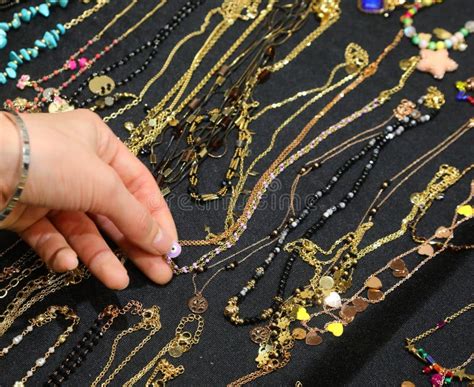 Hand Of Young Girl Who Is Choosing A Necklace In The Jewelry Store