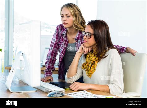 Two Girls Use A Computer Stock Photo Alamy