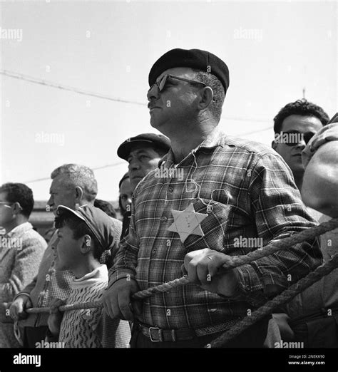 An Immigrant To Israel From Europe Proudly Wears Star Of David As He Stands With Spectator