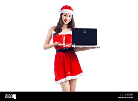 Asian Christmas Girl With Santa Claus Clothes Holding Laptop Isolated