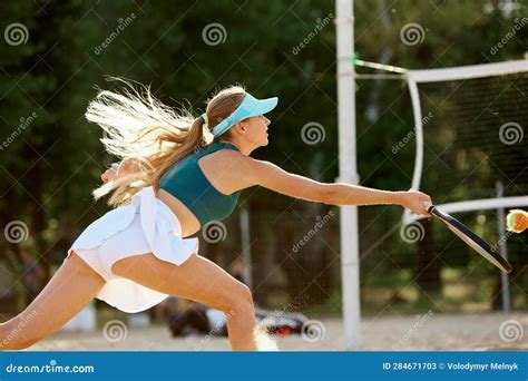 Dynamic Image Of Young Woman Professional Tennis Player During Game On