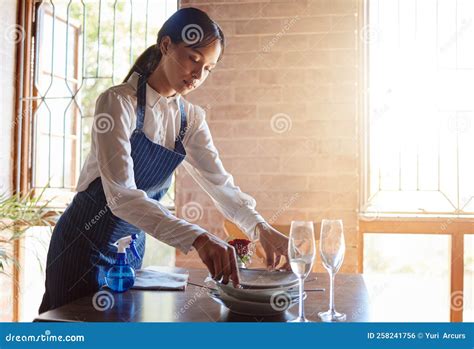 Restaurant Waitress Cleaning Dishes From Table After A Meal Customer