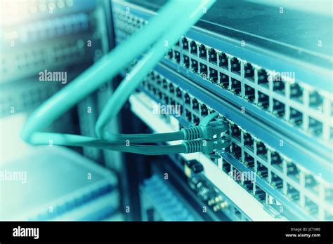 Network Cable Connecting On Network Core Switch Close Up Stock Photo