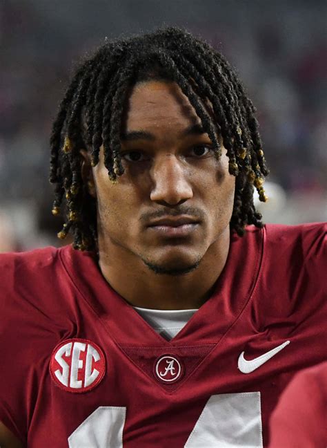 Download Focused Football Player Portrait Wallpaper