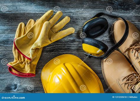 Leather Protective Gloves Boots Hard Hat Earmuffs On Wooden Boar Stock