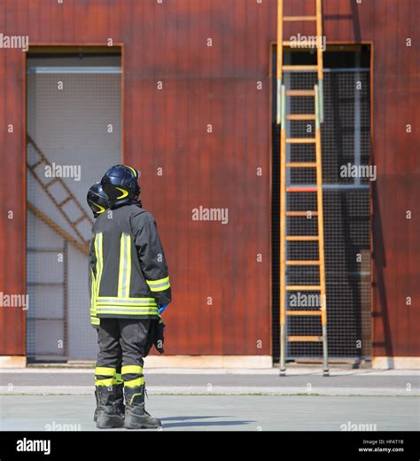Two Firefighters During A Training Exercise In The Firehouse Stock