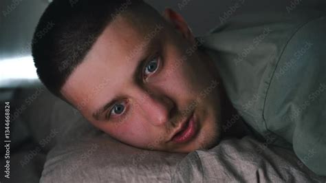 A Man Woke Up From A Terrible Dream A Man On A Bed Wakes Up With A