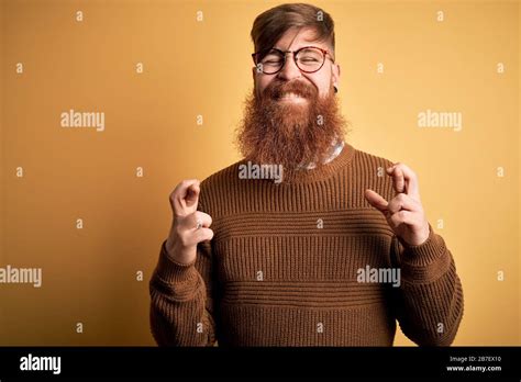 Handsome Irish Redhead Man With Beard Wearing Glasses And Winter