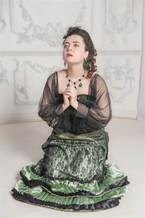 Sad Woman Wearing Green Medieval Vintage Victorian Style Dress Pray