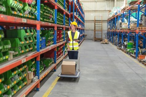 Premium Photo A Female Worker Sorting Goods In A Warehouse