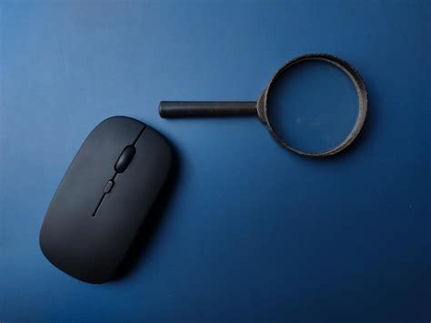 Premium Photo Closeup Magnifying Glass And Wireless Mouse On A Blue Background