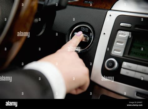 Female Car Driver Pushing Button Stock Photo Alamy