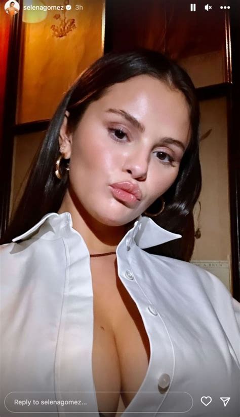 Selena Gomez nearly suffers major wardrobe malfunction as her shirt pops open to reveal black ...
