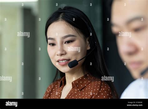 Asian Business Team Engaged In Professional Work Environment Using