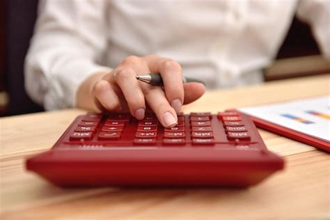 premium photo businesswoman hand using calculator