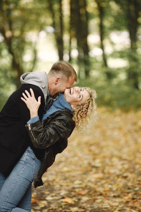 Romantic Couple Standing In A Forest Hugging And Posing For A Photo