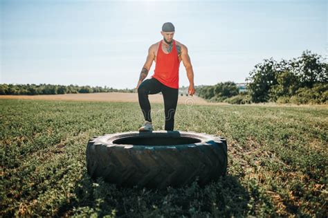 Outdoor Crossfit Exercise Strong Man And Crossfit Wheel Stock Image