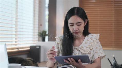 Dolly Out Shot Of Young Businesswoman Using A Digital Tablet At