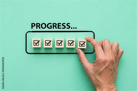 Checklist And Task Progress Tracking Concept A Hand Placing The Final Checkmark On Wooden