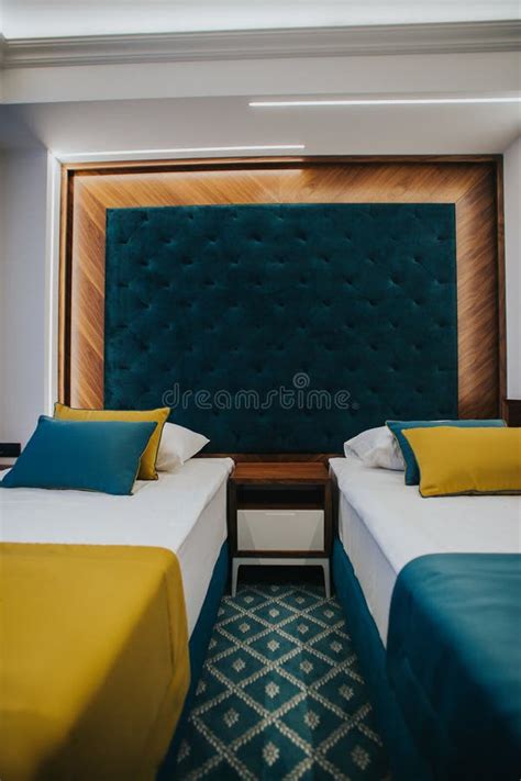 Beautiful Hotel Room With A Wooden Interior Design And Two Single Sided