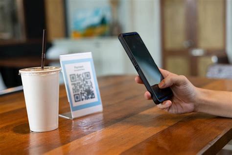 Man Use Smartphone To Scan Qr Code To Pay In Cafe Restaurant With A