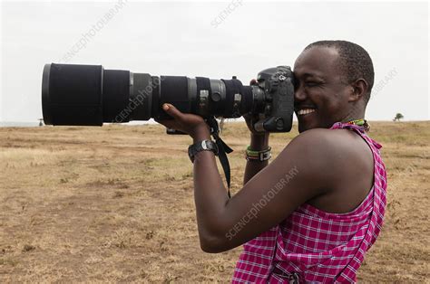 Masai Field Guide Taking Pictures With A Telephoto Lens Stock Image
