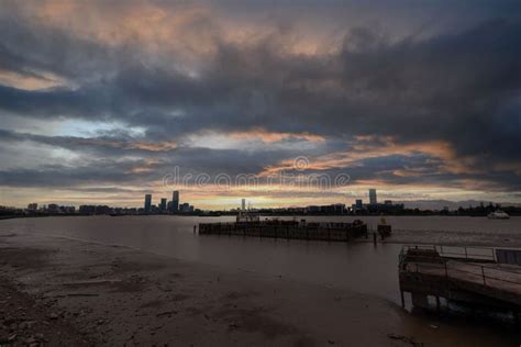 Scenic Shot Of An Empty Beach With A City Skyline In The Background And