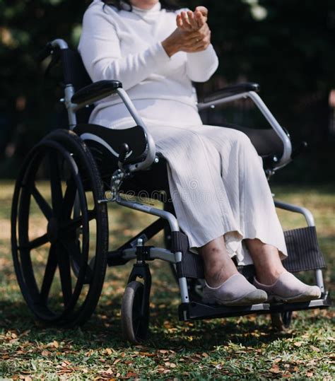 Asian Young Woman Nurse At Nursing Home Take Care Disabled Senior Man
