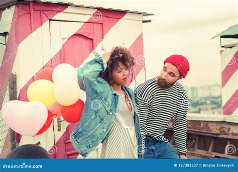 Young Man Looking At His Sleepy Girlfriend After Having Night Party
