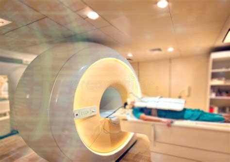 A Patient Lies Down Comfortably On The Mri Scanner Undergoing A