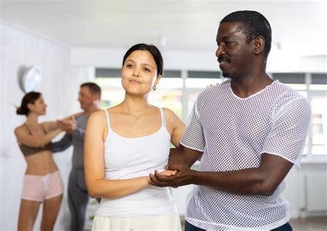 Positive Woman And African American Man Practicing Bachata Dance Moves