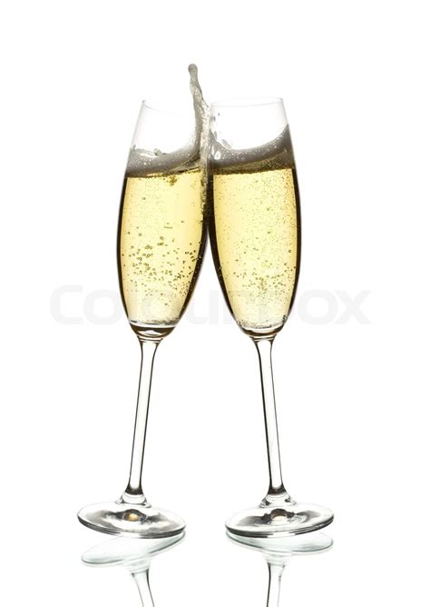 Two Glasses Of Sparkling Wine Clinking Over White Stock Image