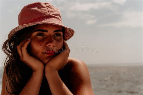 Happy Young Woman Sunbathing Or Tanning On A Seaside Beach During