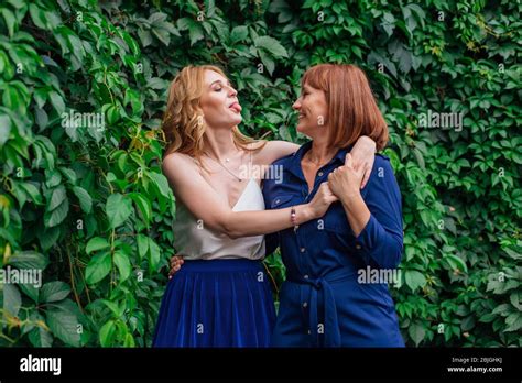 Beautiful Mother And Her Grown Up Daughter Hugging Each Other On A