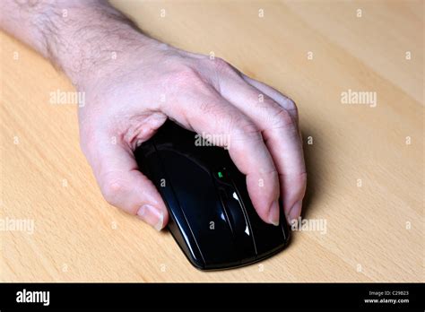Hand Using A Modern Wifi Cordless Computer Mouse Stock Photo Alamy