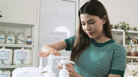 Female Customer Fills Liquid Products From Reusable Containers In Refill Store Stock Footage