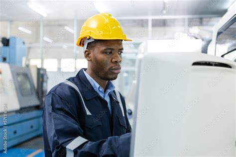 Man African American Engineer Using Computer Controlling Cnc Machine At