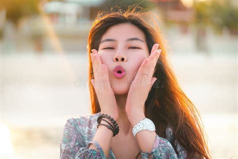 Young Woman On A Beach With Surprised Face Expressing Wow Emotion For