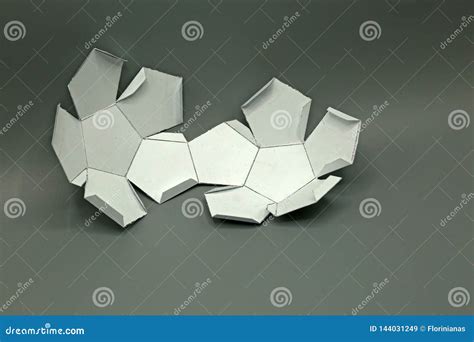 Geometric Shape Cut Out Of Paper And Photographed On Grey Background Dodecahedron D Shape