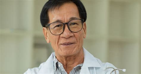 성공적이고 자신감 있는 중년 전문 남성 의사의 초상화가 흰색 의료 가운을 입고 팔짱을 끼고 있다 사진 Unsplash의