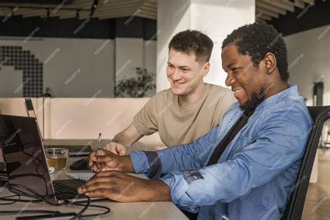 Premium Photo Two Smiling Positive Programmers Working In The Office