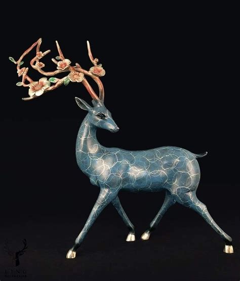 bronze deer sculpture with floral antlers